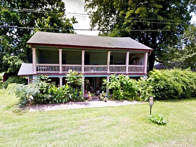 This historic home with its welcoming porch practically whispers stories of generations past—architectural poetry in wood and white columns.