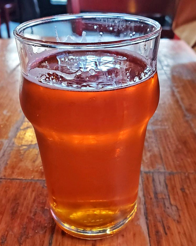 Amber nectar in a glass bearing the restaurant's name. The perfect companion to balance the rich, smoky flavors that dominate the MEAT BBQ experience.