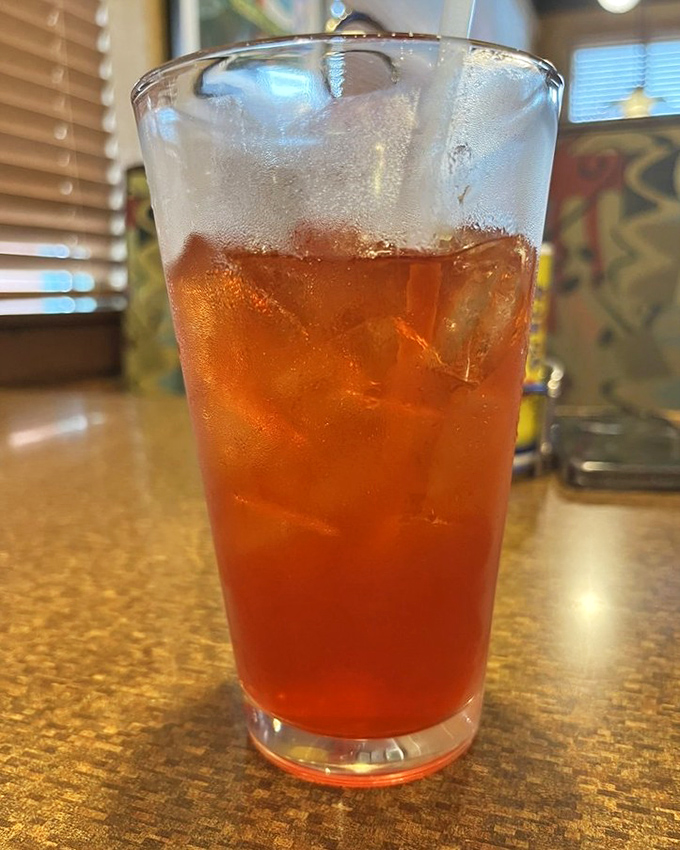 Hurricane cocktail glowing amber like a Gulf Coast sunset, minus the sand in your shoes.