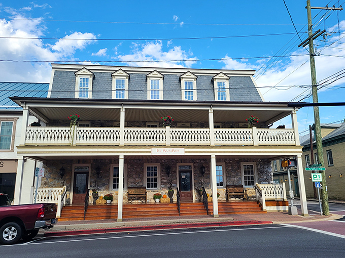 Inn BoonsBoro's front porch invites weary travelers to sit a spell, its rocking chairs promising respite and its stone walls whispering centuries of secrets.
