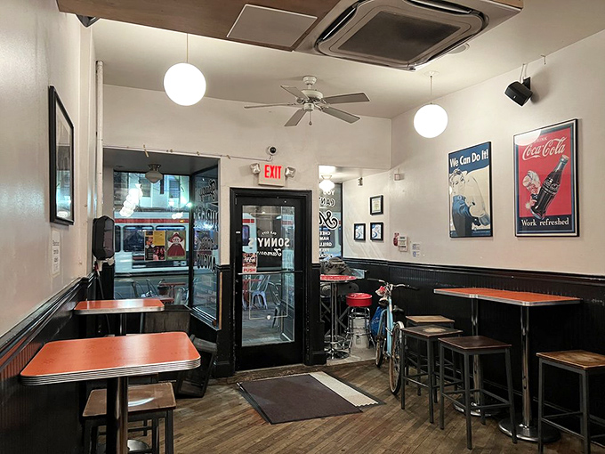 Vintage Coca-Cola ads and simple globe lights create that timeless diner atmosphere where comfort food and nostalgia make everything right with the world.