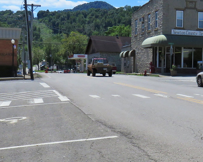 Historic storefronts preserve that classic Ozark architecture while hills rise dramatically behind them like nature's exclamation point.