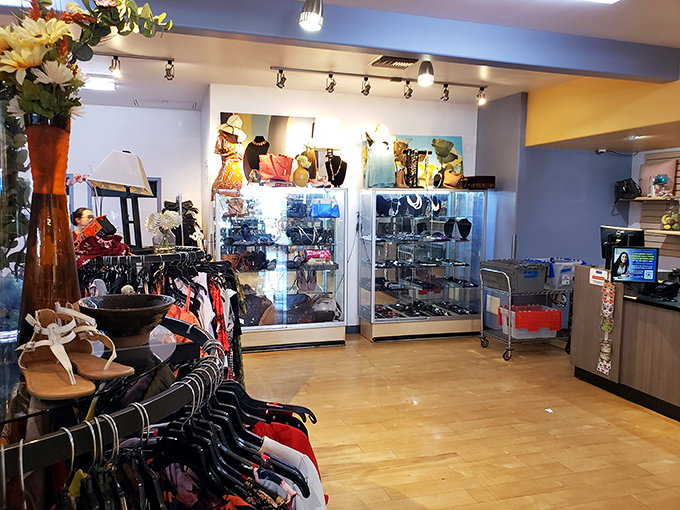 The jewelry and accessories section gleams under display case lights, showcasing everything from vintage brooches to contemporary statement pieces at fraction-of-retail prices.