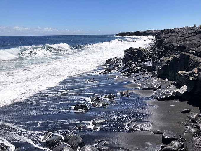 Kaimu's black sand beach performs nature's alchemy &ndash; yesterday's fiery lava transformed into today's obsidian shoreline where ocean meets land.