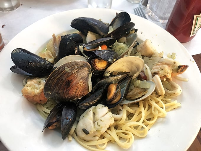 Linguini playing host to a neighborhood meeting of mussels, clams and shrimp in a garlicky summit of flavors.