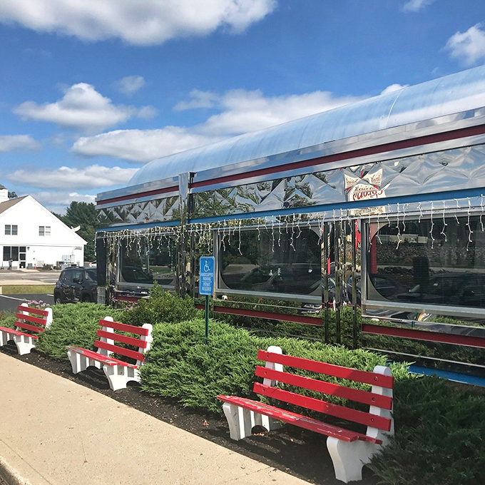 Classic diner car architecture serves up nostalgia before you even order&mdash;red benches outside promise comfort food inside.