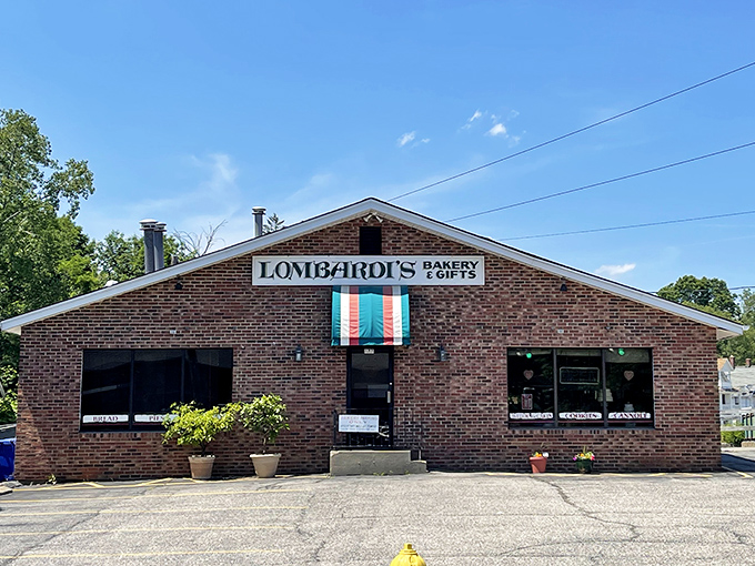 Lombardi's Bakery's Italian flag awning signals what your nose already knows—authentic pastries await inside this unassuming brick building.