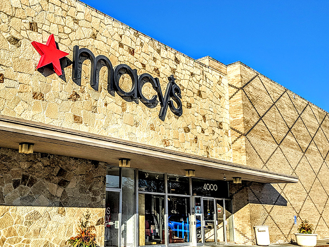Macy's stone facade stands like a retail fortress, promising climate-controlled shopping adventures regardless of Kansas weather tantrums outside.