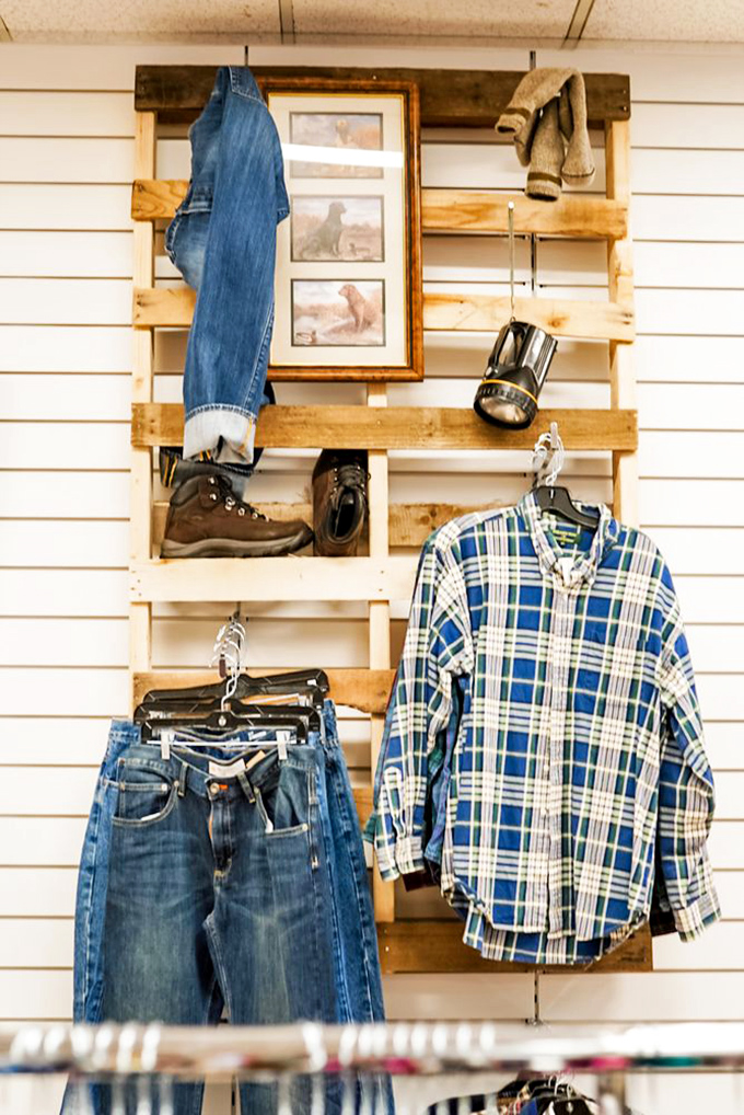 That rustic wooden pallet display showcasing flannel shirts and work boots screams Pinterest-perfect without the Pinterest prices attached.