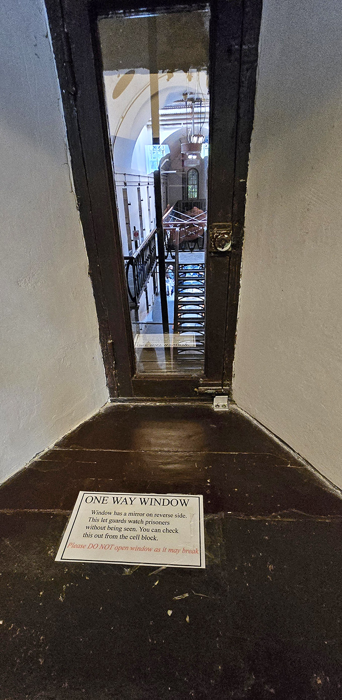 The one-way window: prison's original surveillance camera. Guards could watch without being seen—the 19th-century version of Big Brother is watching you.