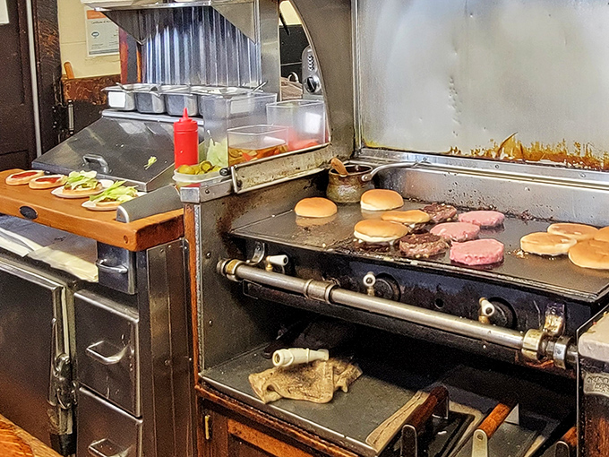 The grill &ndash; seasoned by decades of service, where burgers and breakfast achieve that perfect sear that only comes from years of experience.