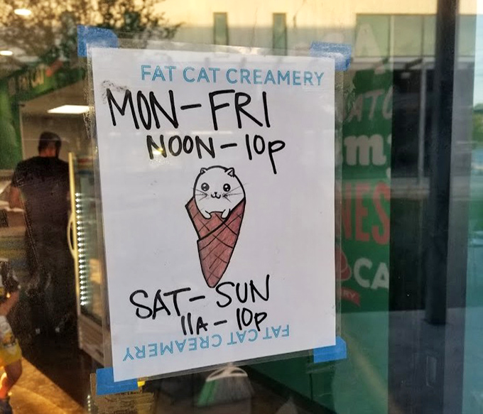 Even the hours sign features a cat in a cone—proof that when your brand is this strong, even your business hours become adorable.