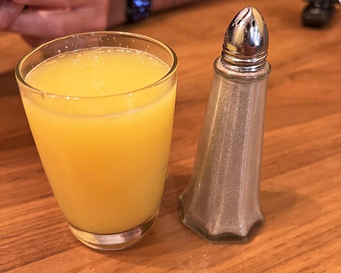 Fresh-squeezed orange juice that captures sunshine in a glass. Paired with that elegant salt shaker, it's breakfast's perfect supporting character.