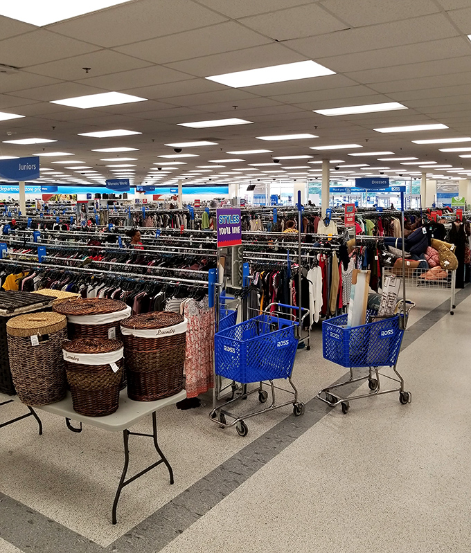 Blue carts navigate the fashion frontier, each one a vessel of possibility in this sea of discount designer finds.