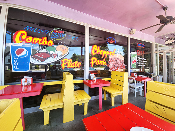 Outdoor seating painted brighter than a Georgia summer day—where picnic tables become the best seats in Atlanta.