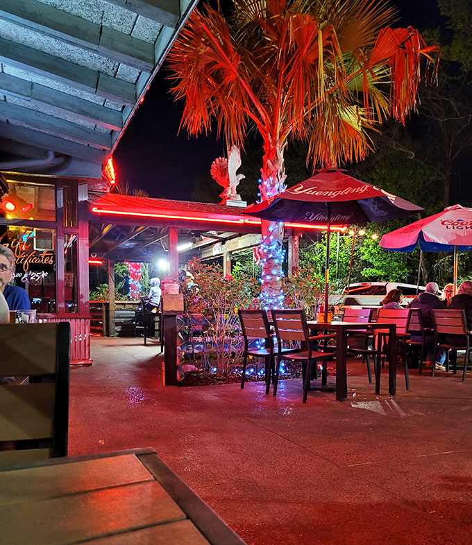 As evening falls, the patio transforms into a twinkling oasis where palm trees sway and conversations flow as freely as the drinks.
