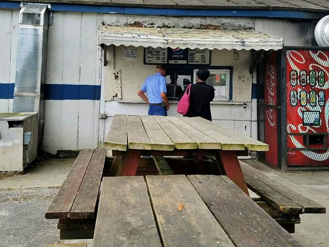 Outdoor seating that's as unpretentious as it gets. Picnic tables where strangers become friends, united by the universal language of great barbecue.