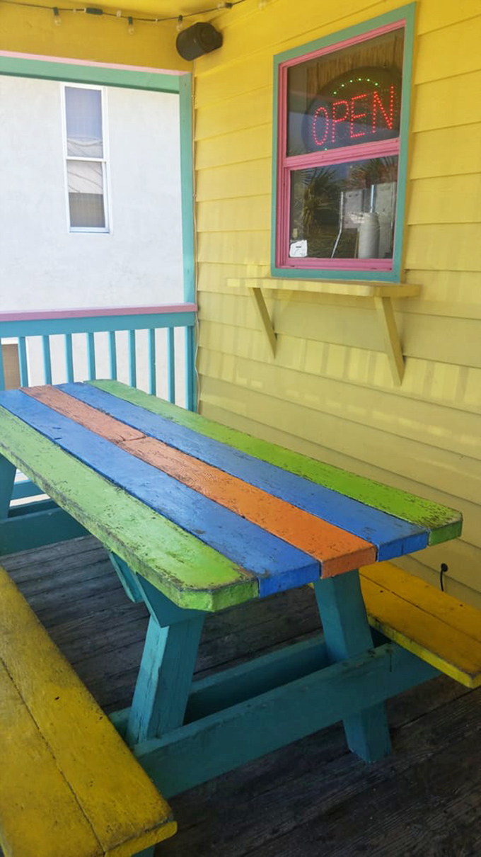 Rainbow picnic table that seems to say, "Slow down, enjoy your cone, the beach will still be there when you're done."