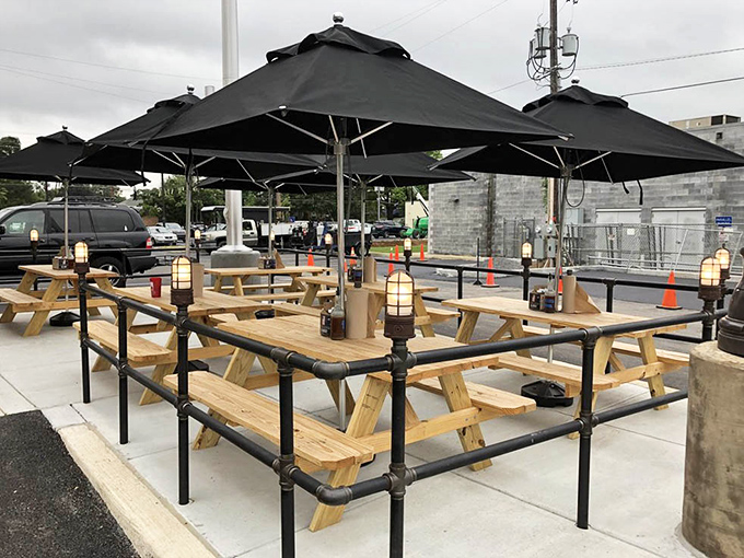 Outdoor picnic tables under umbrellas invite al fresco dining where eating ribs in fresh air somehow makes the experience even more satisfying.