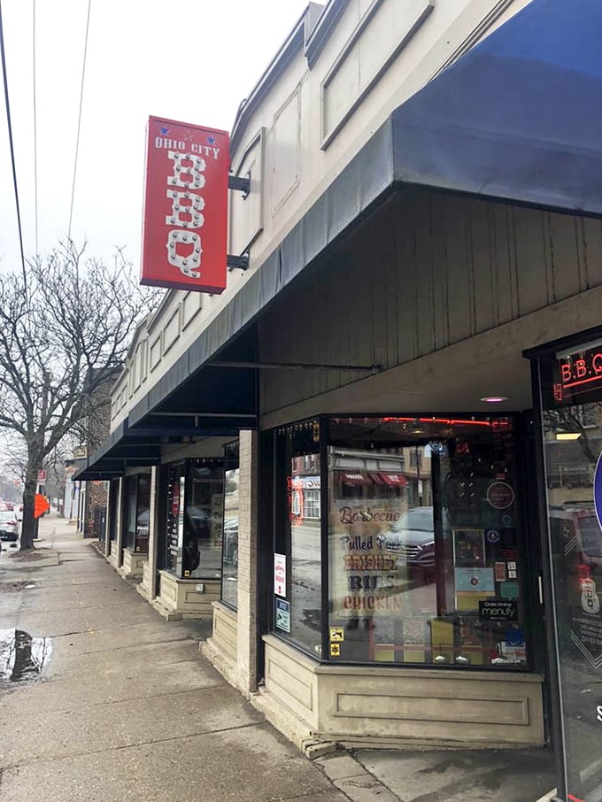 Even on gray Cleveland days, that red BBQ sign promises warmth, smoke, and satisfaction waiting just inside.