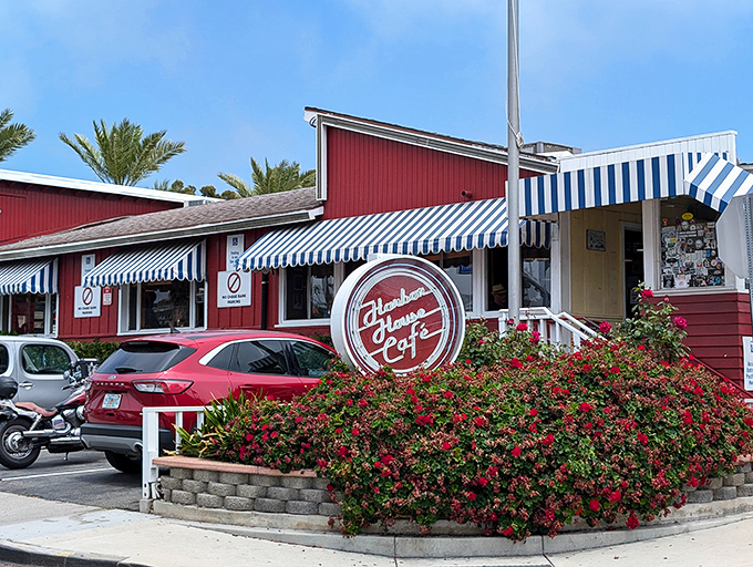 In the California sunshine, Harbor House's red siding and blue-striped awnings look like they've been plucked straight from a nostalgic postcard.