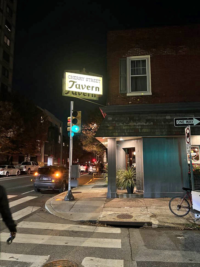 As night falls on Cherry Street, the tavern's illuminated sign serves as a beacon for sandwich pilgrims and thirsty travelers alike.