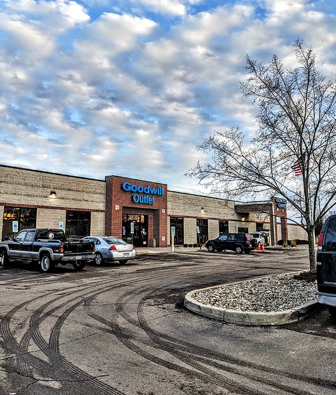 The calm before the shopping storm. Cars gather like prospectors at a gold rush, each driver hoping to strike secondhand riches inside. 