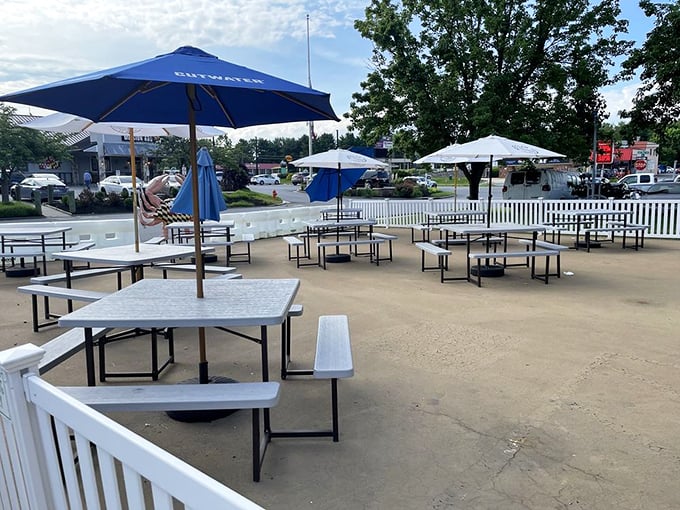 Outdoor seating under blue umbrellas offers the perfect spot to crack crabs while soaking up Maryland sunshine. Napkins are non-negotiable.