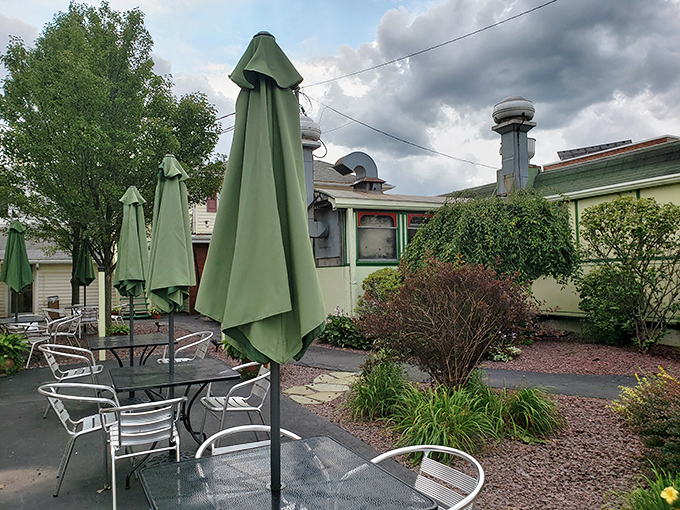 Even the outdoor seating area maintains the diner's unpretentious charm. Those green umbrellas have sheltered countless conversations and coffee breaks from summer sun.