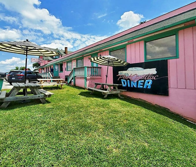 Outdoor seating with striped umbrellas adds fair-weather charm to the Pink Cadillac experience. Picnic tables invite leisurely meals under Virginia skies.
