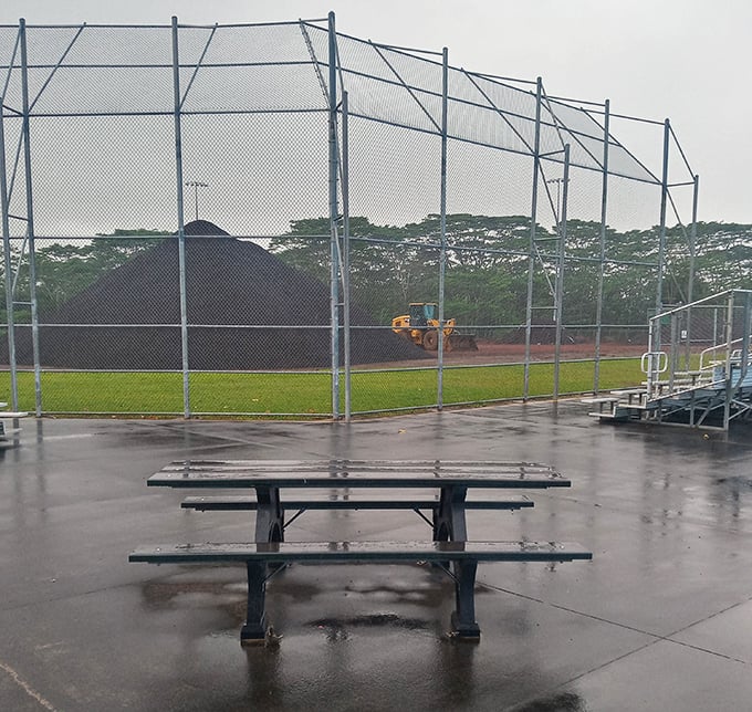 Rain-slicked benches overlooking quiet fields&mdash;the perfect metaphor for Pahoa's patient resilience. Baseball waits for no volcano.