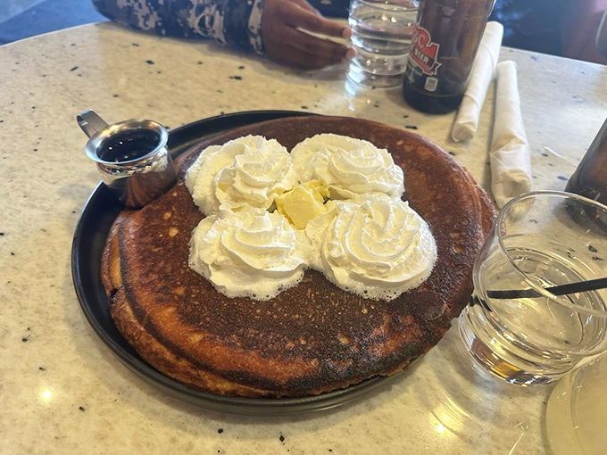 Pancake perfection isn't just about the cake—it's about those four pillowy dollops of whipped cream and the puddle of melting butter in the center.