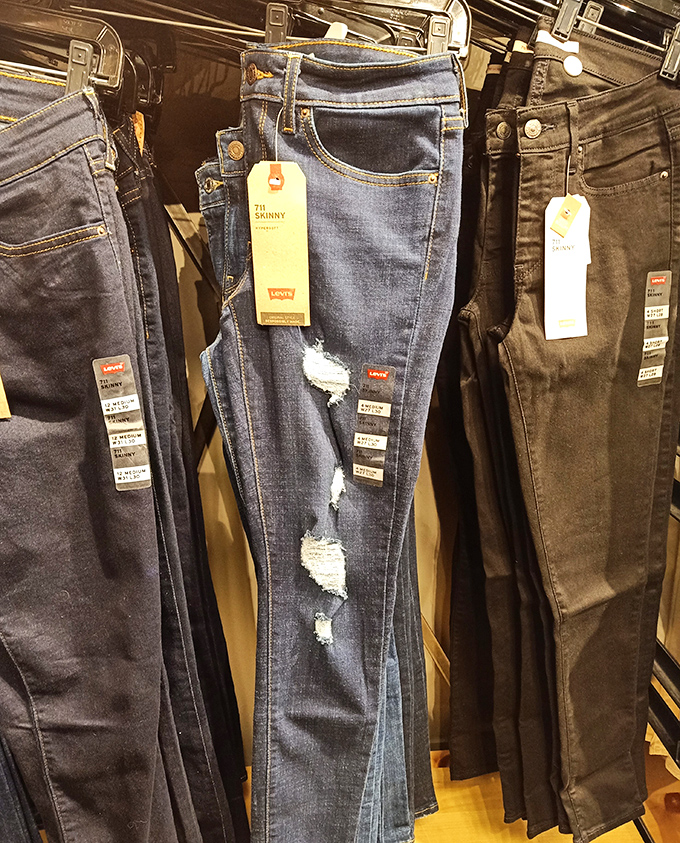 Levi's jeans with strategic distressing&mdash;factory-made holes that somehow cost less than the jeans without holes. Fashion logic at its finest.