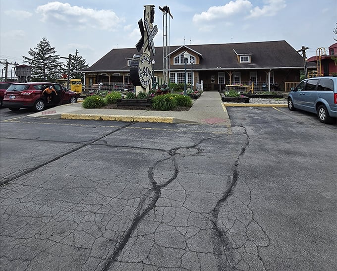 The journey to flavor town begins in this parking lot, where anticipation builds with every step toward those wooden doors.