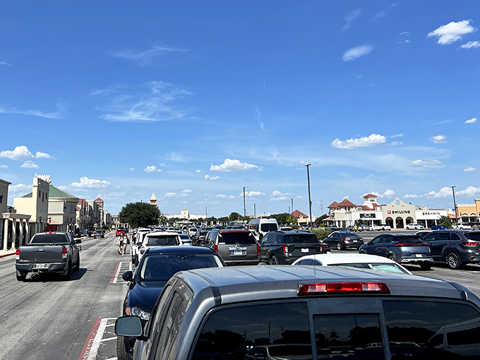 The parking lot at high noon&mdash;a sea of vehicles under that famous Texas sky, each representing someone's retail therapy session.