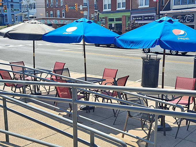 Outdoor seating with Pepsi umbrellas offering shade for summer dining. Pennsylvania sunshine tastes better with a side of diner fries and people-watching.