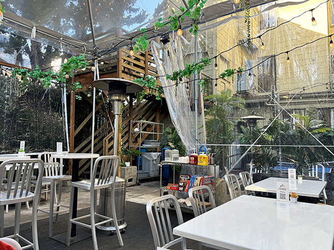 The covered patio offers a serene escape from city bustle. String lights add that touch of urban garden party charm.