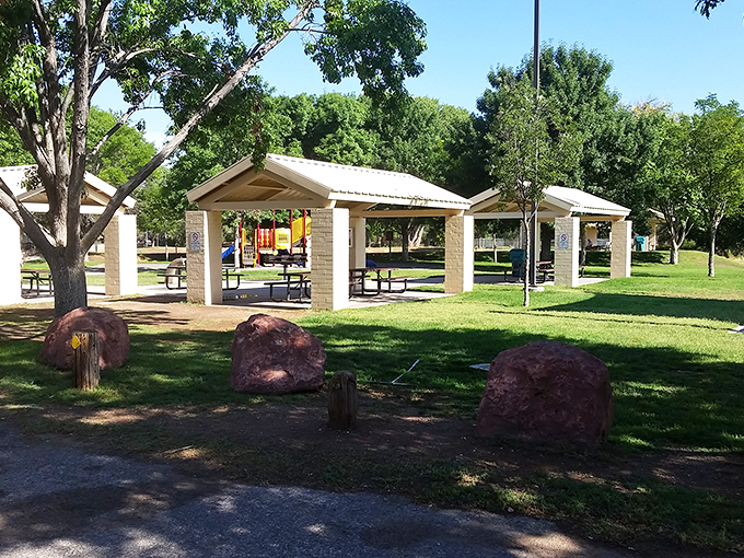 Simple pleasures abound at this picnic area where shade structures, red rocks, and green grass create the perfect spot for an afternoon escape.