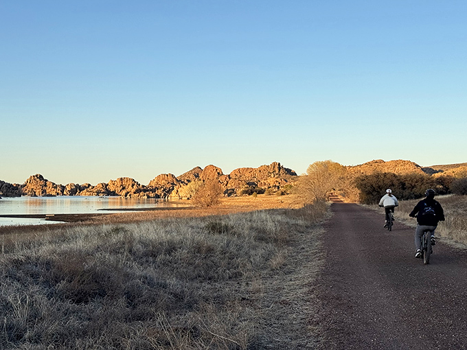 Cyclists enjoy the Peavine Trail at sunset, where granite formations glow amber and the only traffic jam involves deciding who gets to lead.