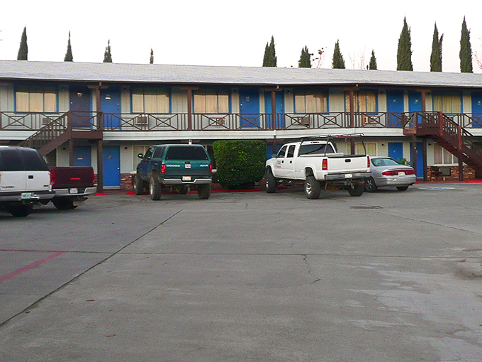 The classic roadside motel &ndash; where mid-century charm meets practical accommodations in a delightful blue that screams "American road trip."