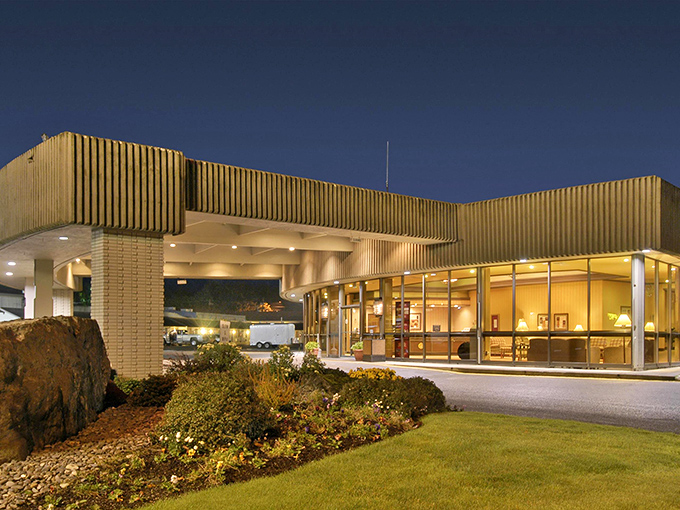 Mid-century modern meets coastal comfort at this distinctive hotel, where the warm glow of evening lights promises weary travelers a place to rest.
