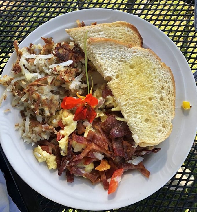 Breakfast alchemy at its finest – scrambled eggs dancing with bacon and veggies, accompanied by toast that's achieved golden perfection.