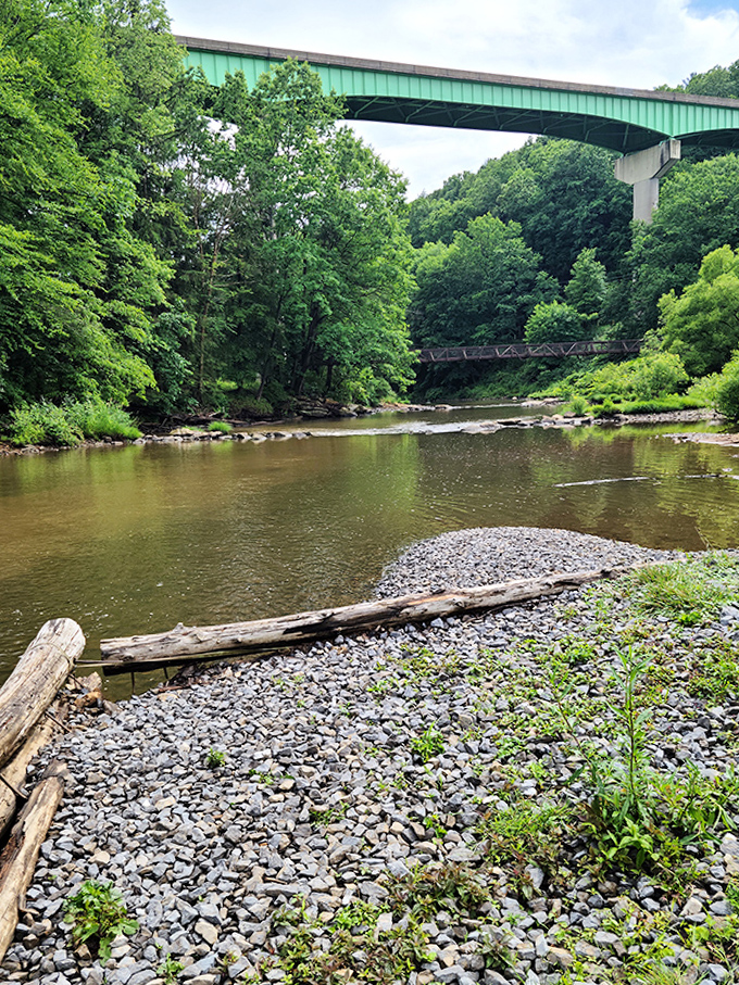 Two bridges&mdash;one practical, one historic&mdash;span the gentle waters below. Engineering from different eras sharing the same peaceful view.