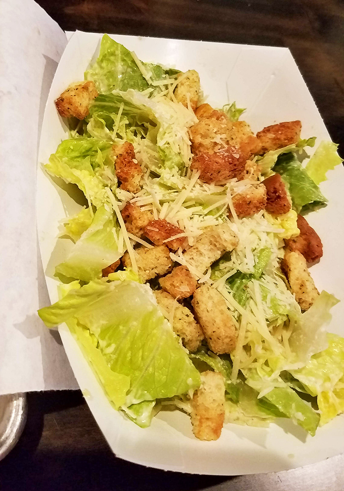 Even the salad looks like it's been invited to the cool kids' table. Crisp, fresh, and unapologetically present among the meat-centric offerings.