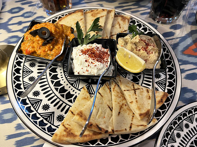 A sampler platter that solves the eternal dilemma of "I want to try everything" with dips, spreads, and flatbread ready for exploration.