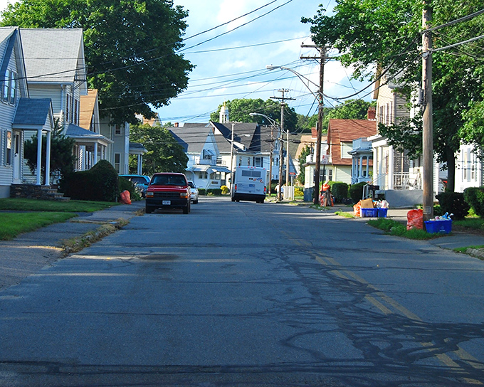 Residential streets lined with well-kept homes showcase Taunton's neighborhood pride. Where recycling bins and American flags stand as suburban status symbols.