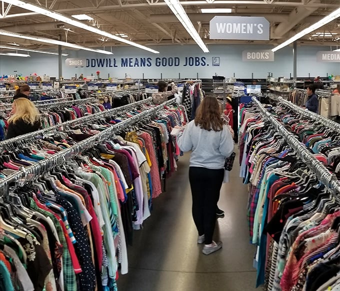 The thrill of the hunt in action. Shoppers navigate the clothing forest where designer labels sometimes hide among everyday brands, waiting for the eagle-eyed to spot them.