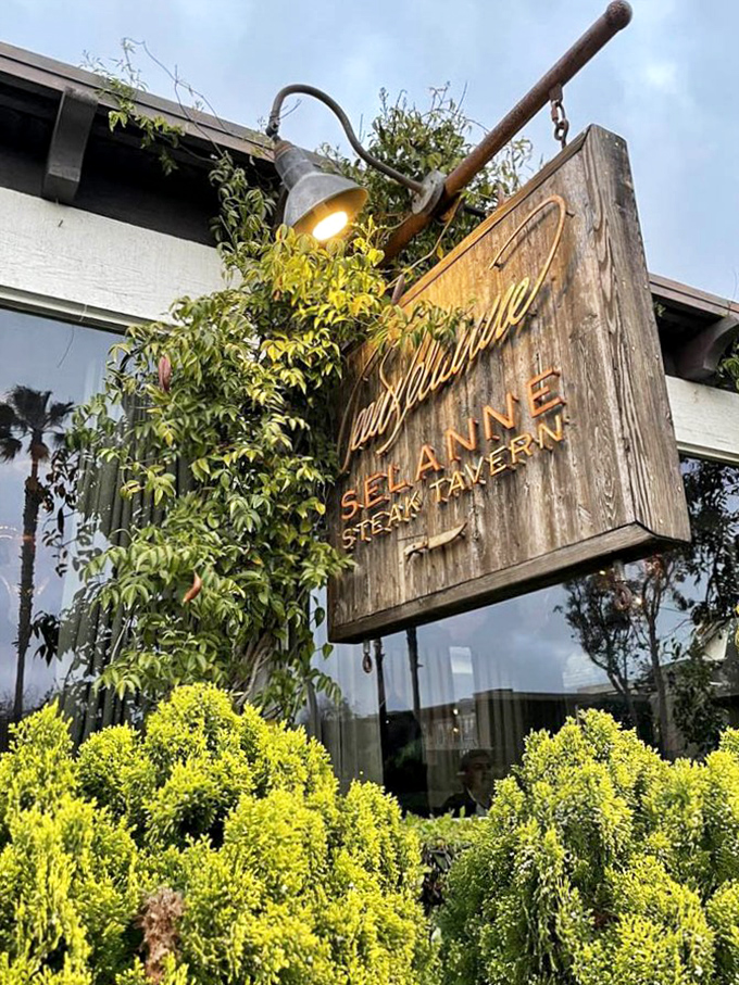 The weathered wooden sign announces your arrival at flavor paradise&mdash;rustic elegance that perfectly telegraphs what awaits inside.