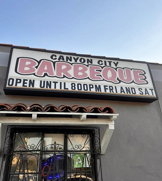 The sign announces extended weekend hours because good barbecue doesn't rush to meet arbitrary closing times. When smoke and time are your main ingredients, patience rules.