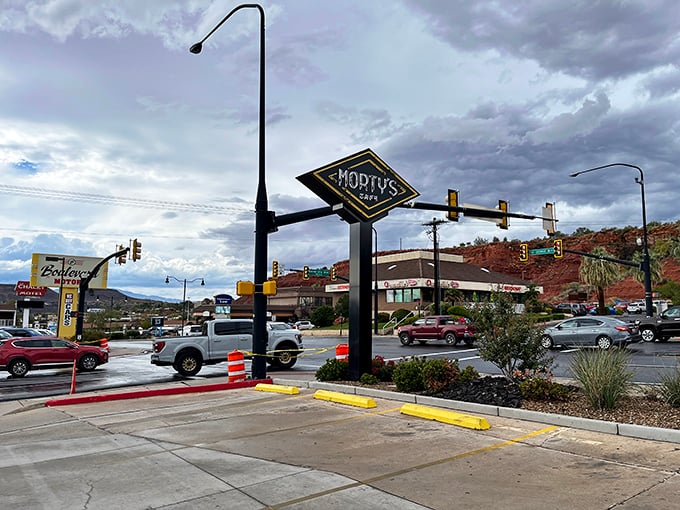 The retro-style sign stands proud against dramatic Utah skies, beckoning hungry travelers like a delicious beacon of hope.